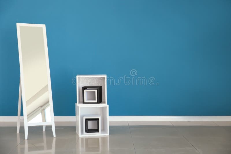 Large Mirror and Shelf Unit Near Color Wall Stock Photo - Image of ...