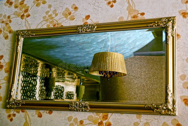 A Large Mirror on the Wall and a Chandelier on the Ceiling in ...