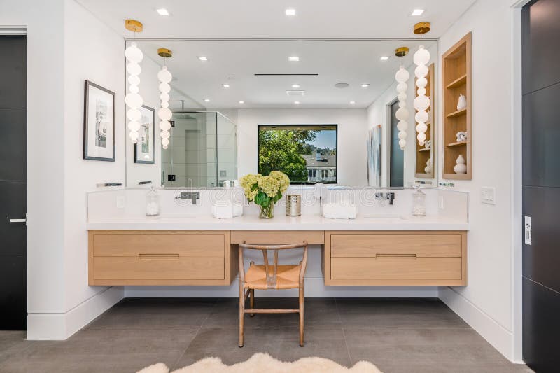 A Large Modern Bathroom with Two Sinks, an Vanity and Two Mirrors Stock ...