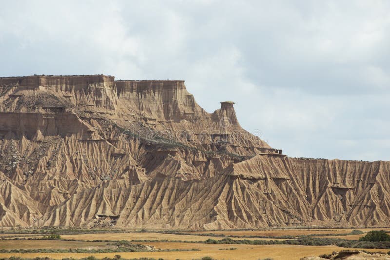 A Large Mountain Range with a Rocky, Barren Landscape. the Sky is ...