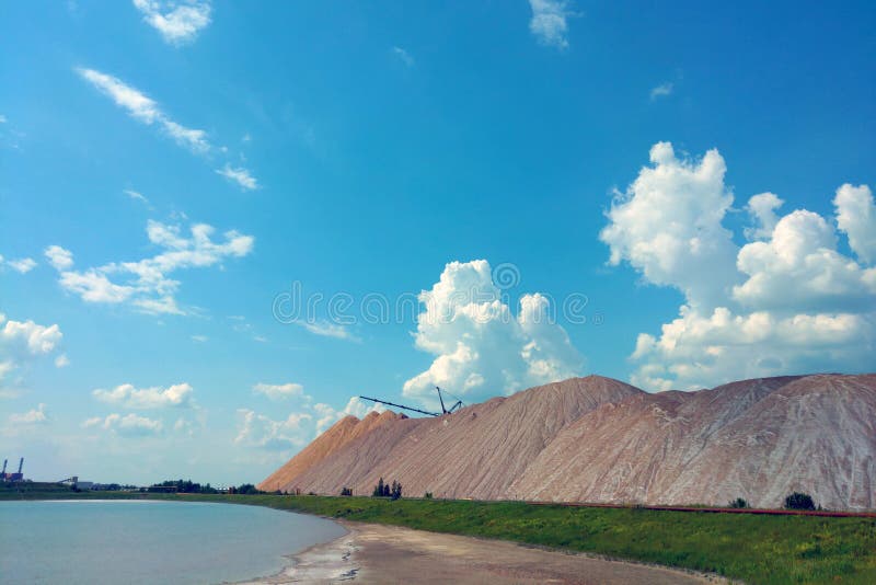 A Large Mountain of Spent Ore Against the Background of a Blue Sky ...