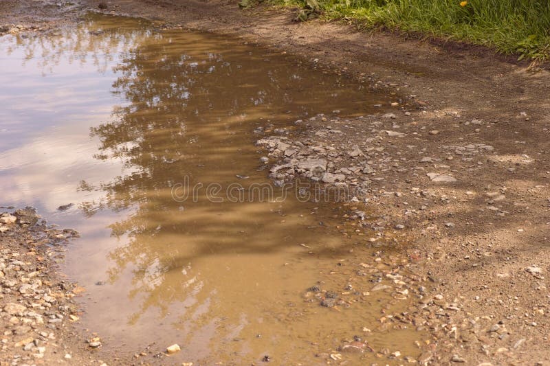 Large Muddy Puddle in a Dirt Road Stock Image - Image of dirt, rain ...