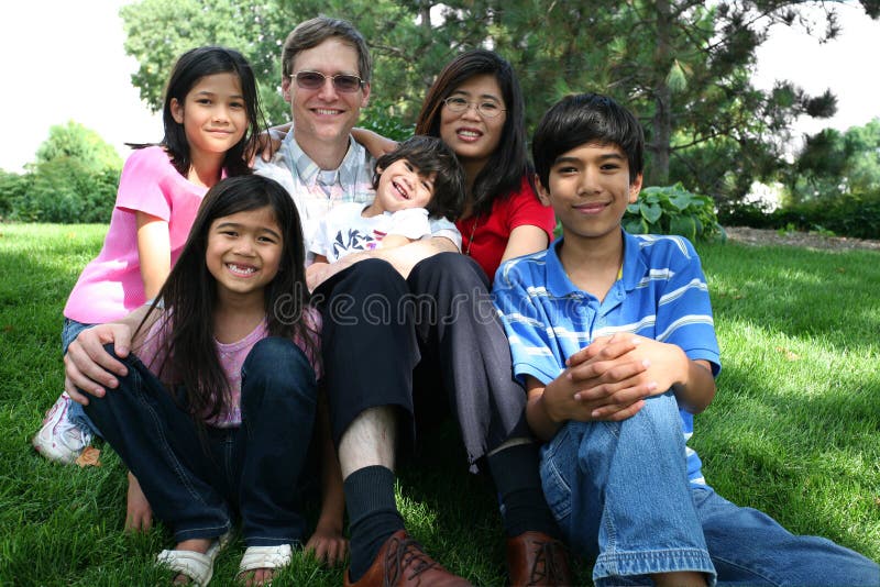 Large Multiracial Family Sitting on Lawn Stock Image - Image of lawn ...