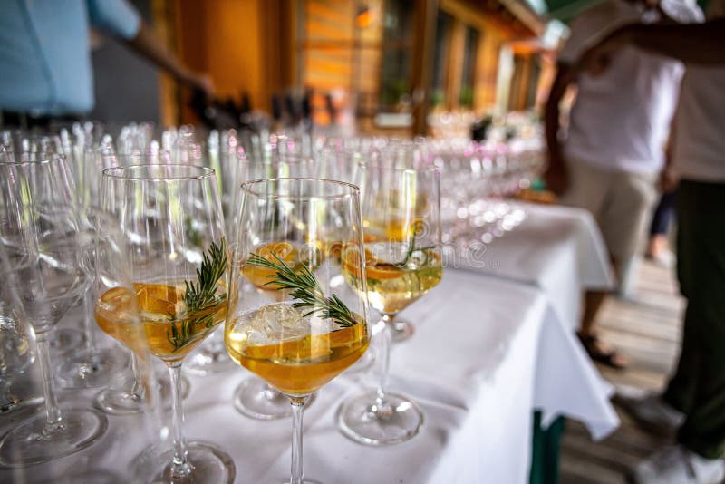 Large Number of Crystal Goblets Some of Which are Filled with an Orange ...