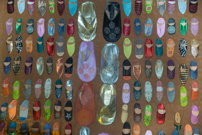 A Large Number of Slippers of Different Colors and Sizes Hang on the ...
