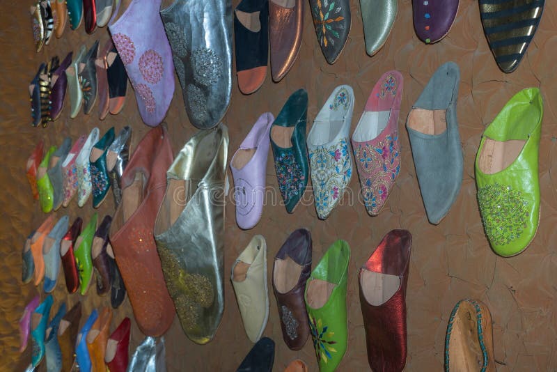 A Large Number of Slippers of Different Colors and Sizes Hang on the ...