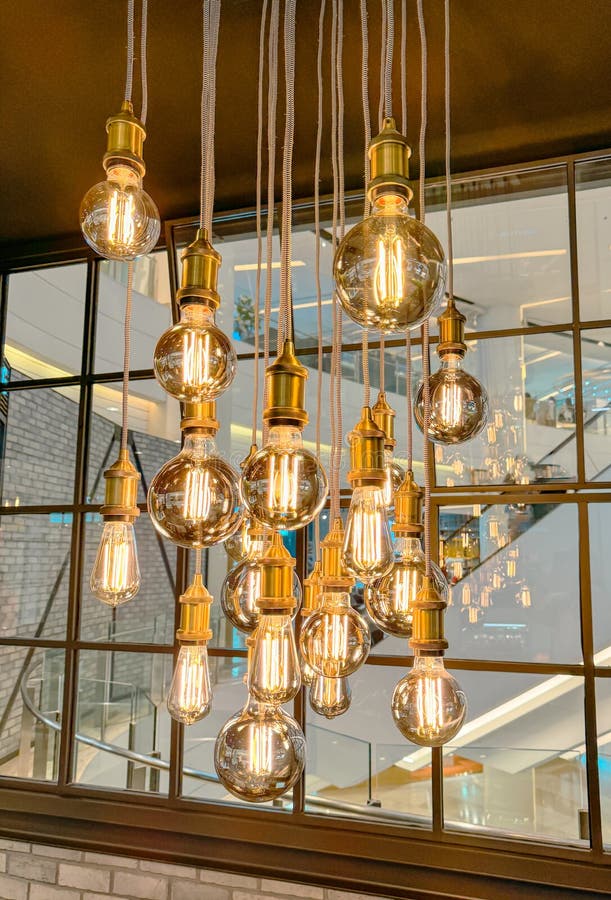 A Large Number of Vintage Light Bulbs are Hanging from the Ceiling ...