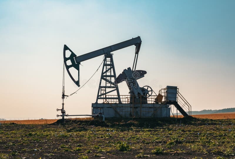A Large Oil Pump Jack Operates in an Open Field, Extracting Crude Oil ...