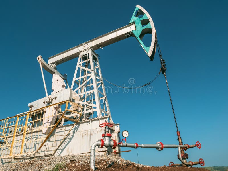 A Large Oil Pump Jack Operates in an Open Field, Extracting Crude Oil ...