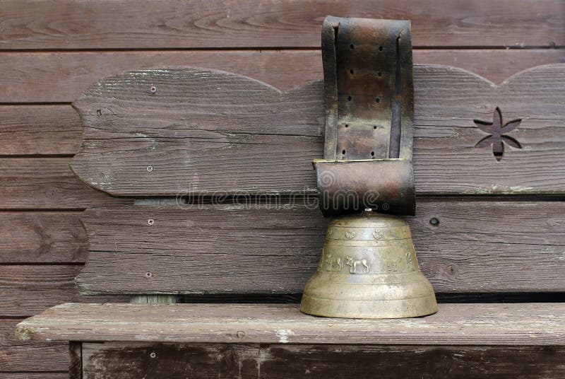 A Large Old Brass Cowbell on a Wooden Bench Stock Photo - Image of ...