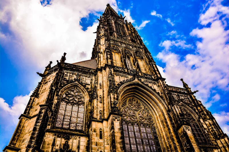 A Large, Old Building with a Steeple and a Clock Tower Stock Image ...