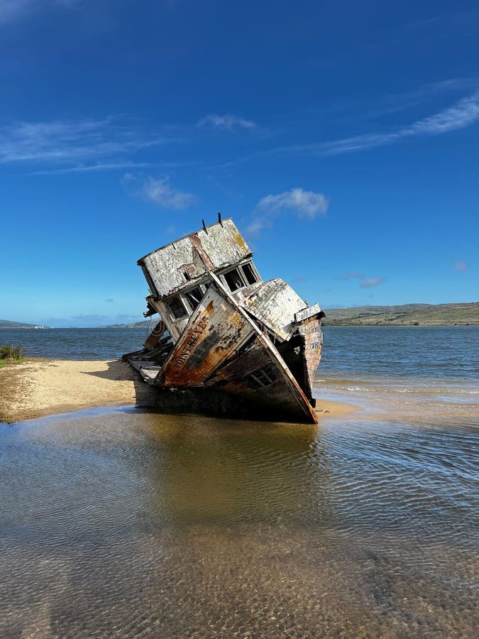 Large Old Shipwreck on a Beach Near a Tranquil Body of Water Stock ...