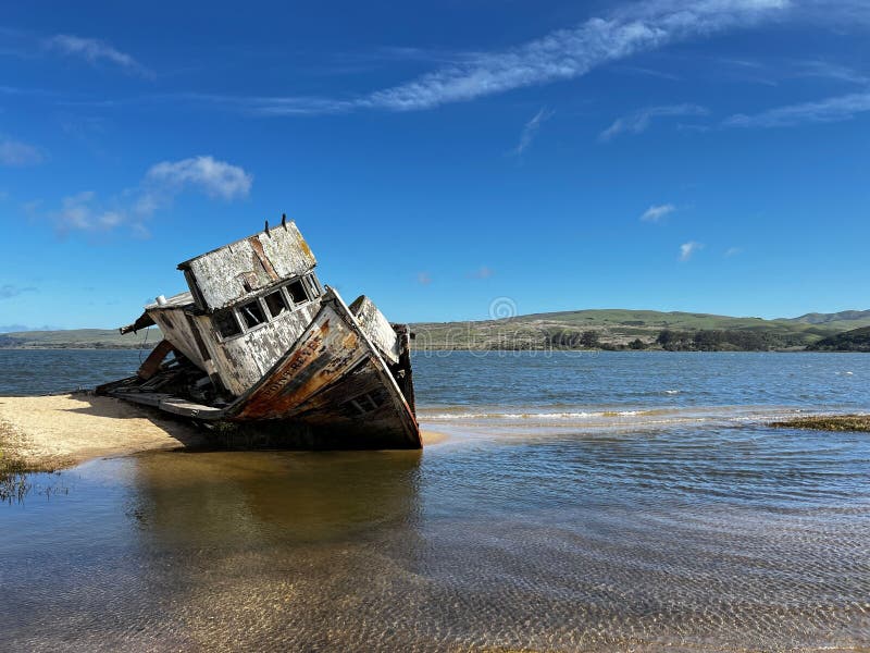 Large Old Shipwreck on a Beach Near a Tranquil Body of Water Stock ...