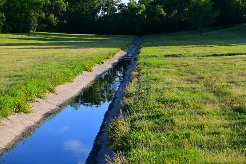 Large Open Field Storm Drainage Culvert with Trees in Background Stock ...