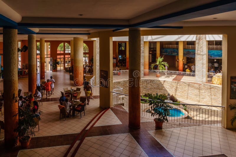 A Large Open Lobby with a Pool and a Few Tables Stock Photo - Image of ...
