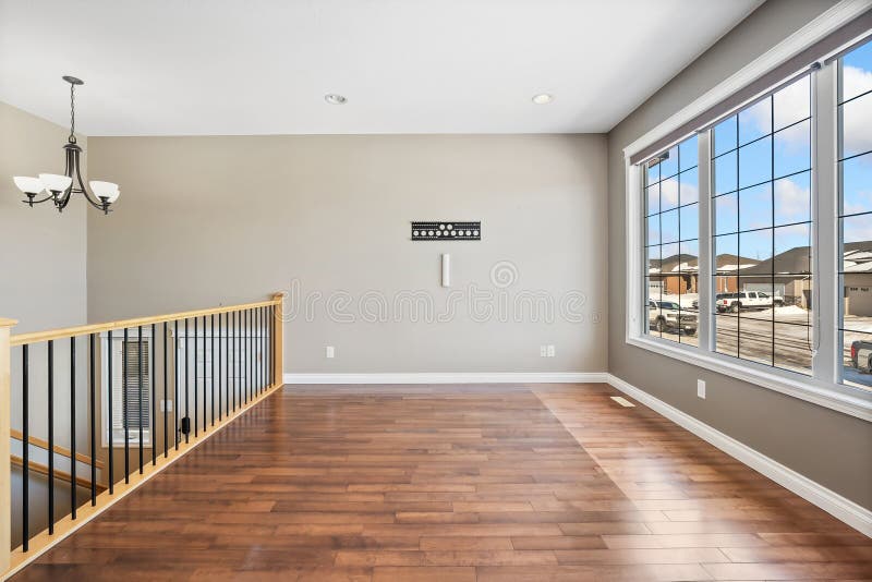 Large Open Room with a Wooden Floor and a Large Window Stock Image ...