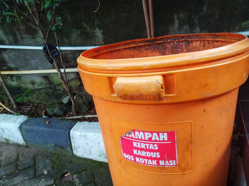 A Large Orange Bucket is Located in a Park for Garbage Disposal. Stock ...