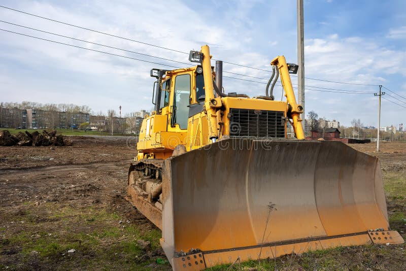 A Large Orange Bulldozer Stands at a Construction Site Stock Image ...