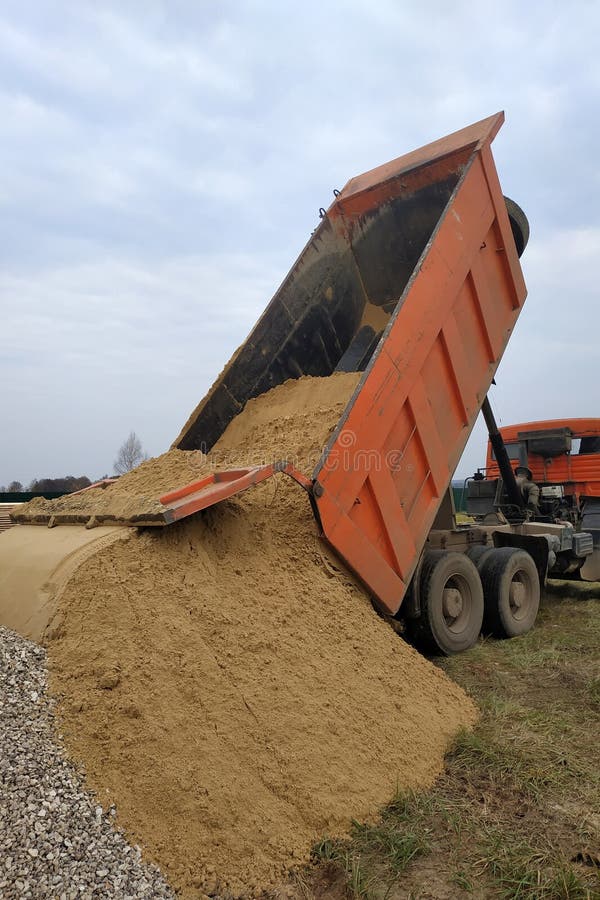 A Large 70-ton Dump Truck Brought Sand To A New Construction Site To ...