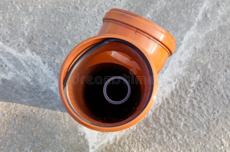 A Large Orange Pipe is Sitting on a Grey Surface Stock Photo - Image of ...
