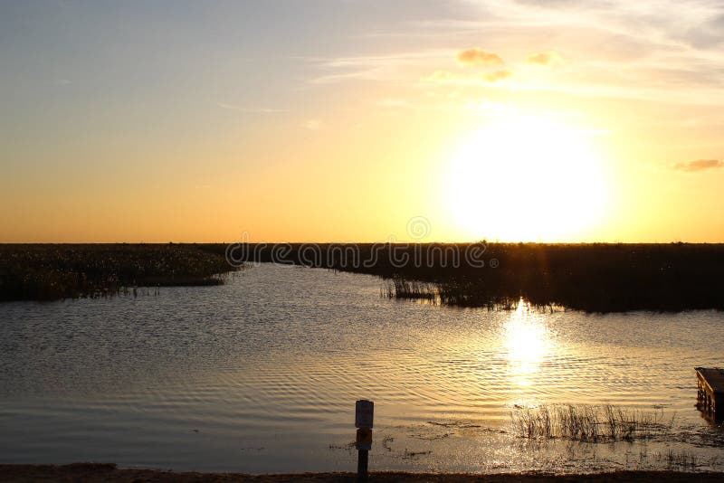 Large Orange Sun Setting in the Water Stock Image - Image of ...
