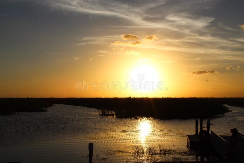 Large Orange Sun Setting in the Water Stock Photo - Image of national ...