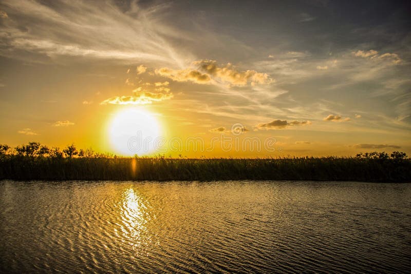 Large Orange Sun Setting in the Water Stock Photo - Image of outdoors ...