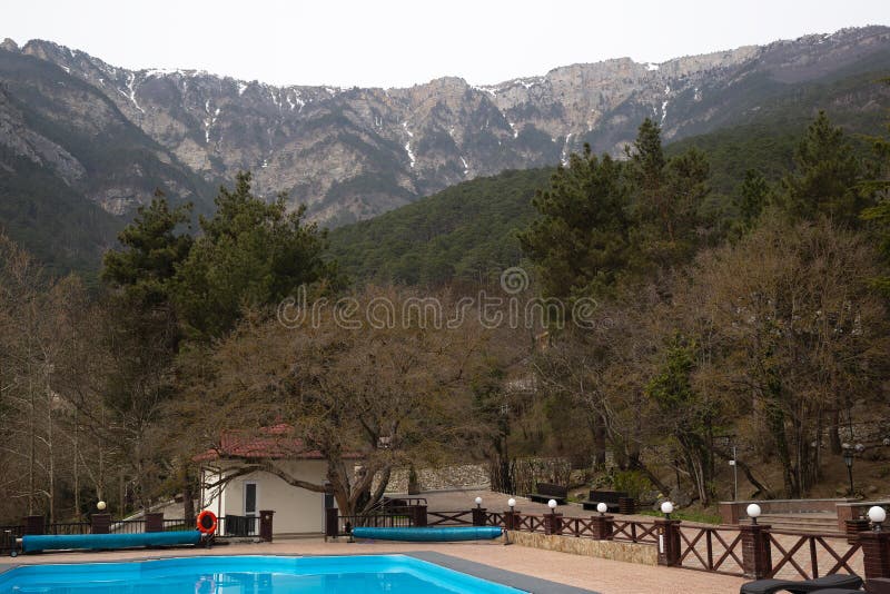 Large Outdoor Swimming Pool Overlooking the Snow-capped Mountains Stock ...