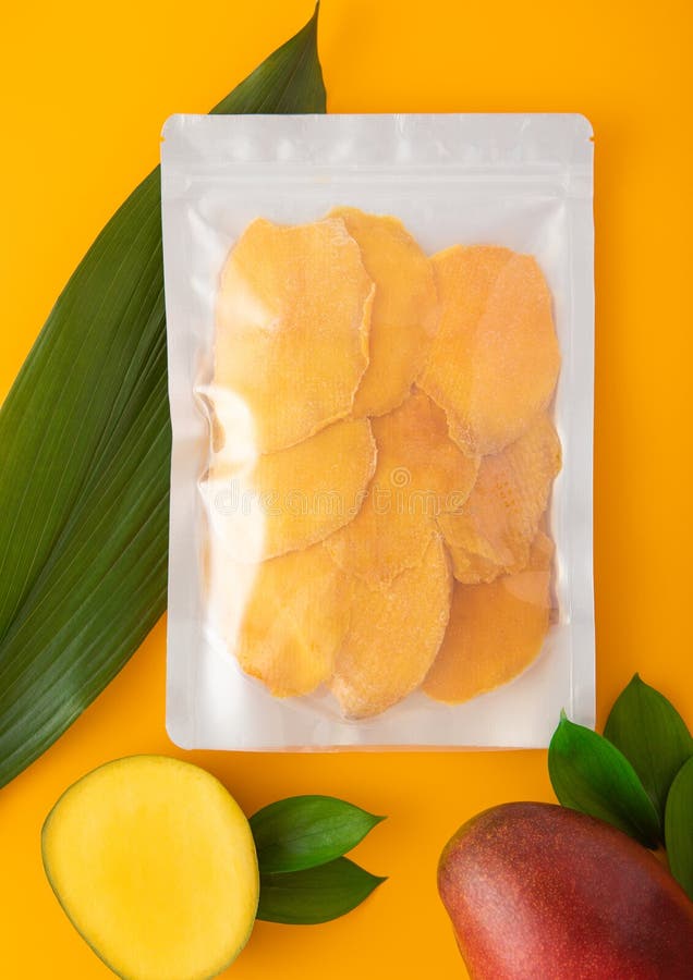 Large Pack of Dried Mango Slices with Leaf and Raw Mango on Yellow ...