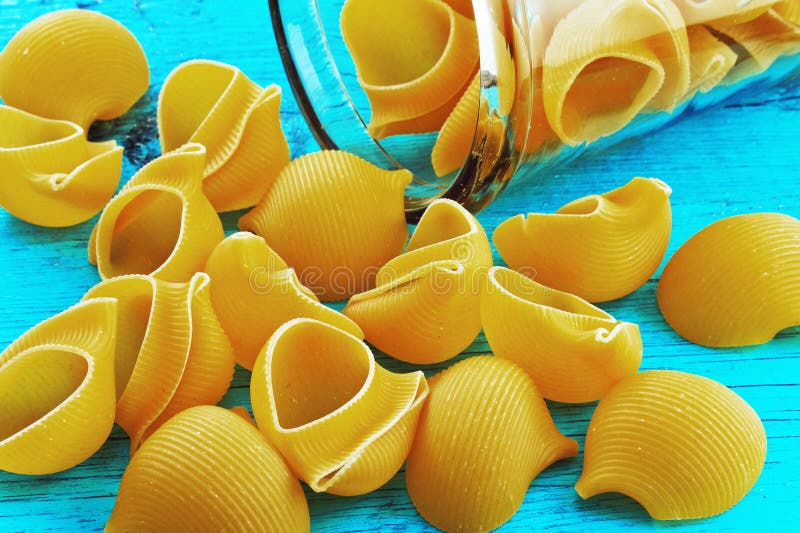 Large Pasta Shells in a Glass Jar on Blue Background Stock Image ...