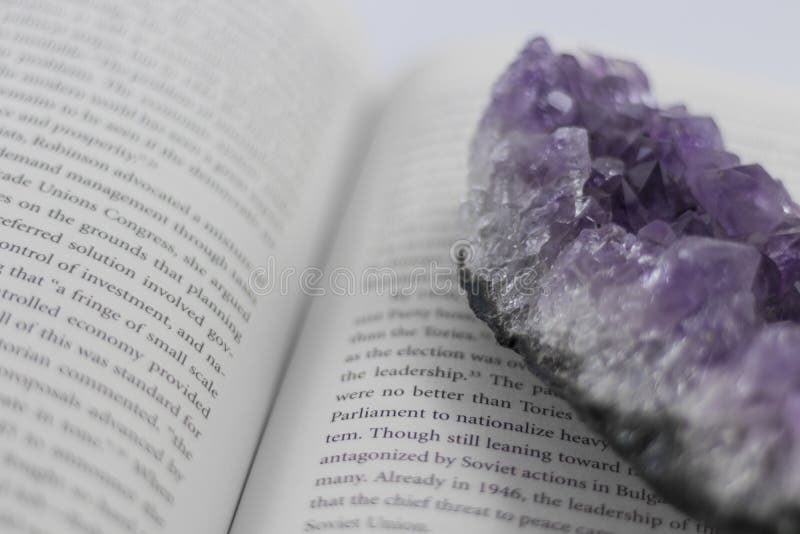 A Large Piece of Amethyst on an Open Book Stock Photo - Image of ...