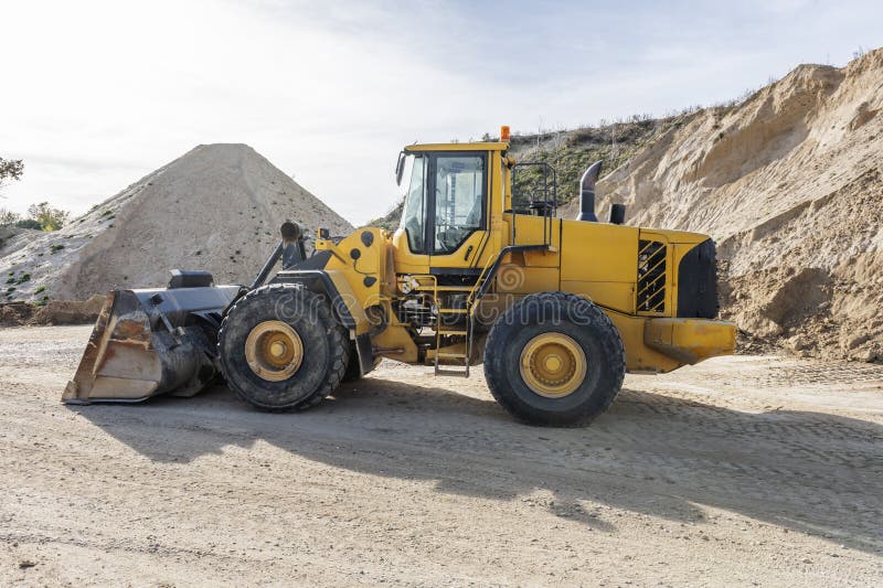 A Large Piece of Construction Machinery Next To Large Mounds of River ...