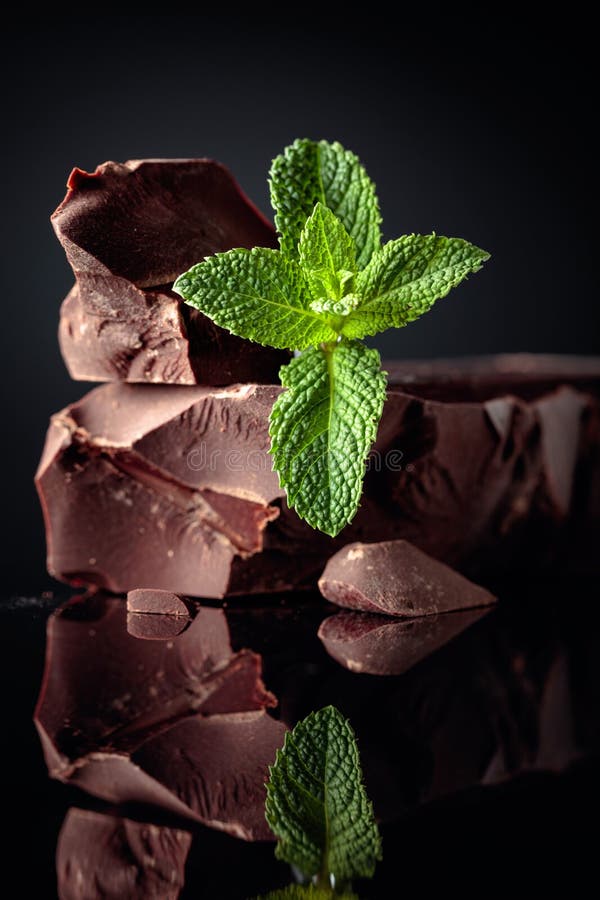 Large Piece of Dark Bitter Chocolate with Mint on a Black Reflective ...