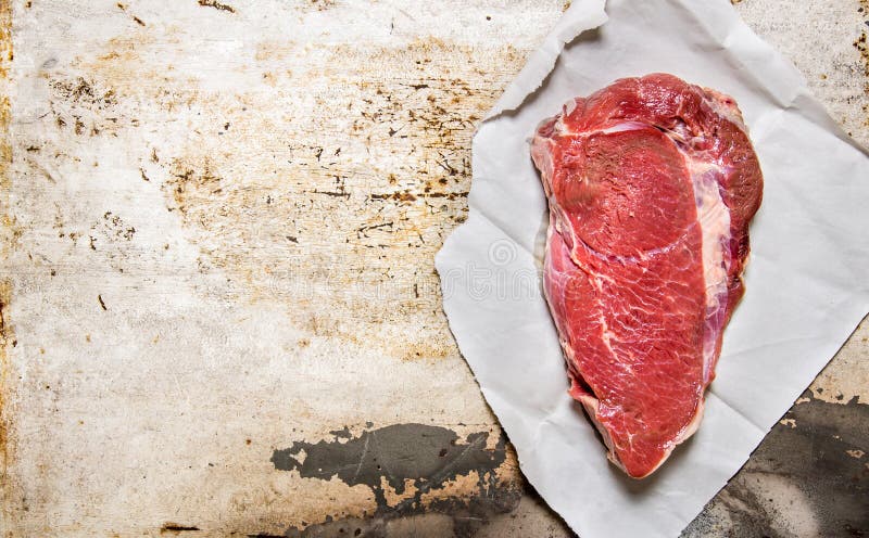 A Large Piece of Raw Fresh Meat on Paper. Stock Photo - Image of ...