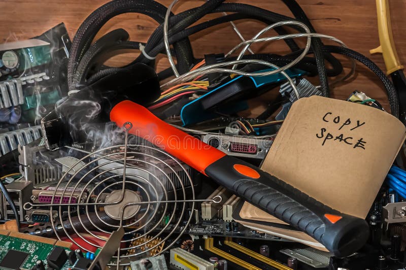 A Large Pile of Computer Components with Tools. Gray Smoke is Streaming ...