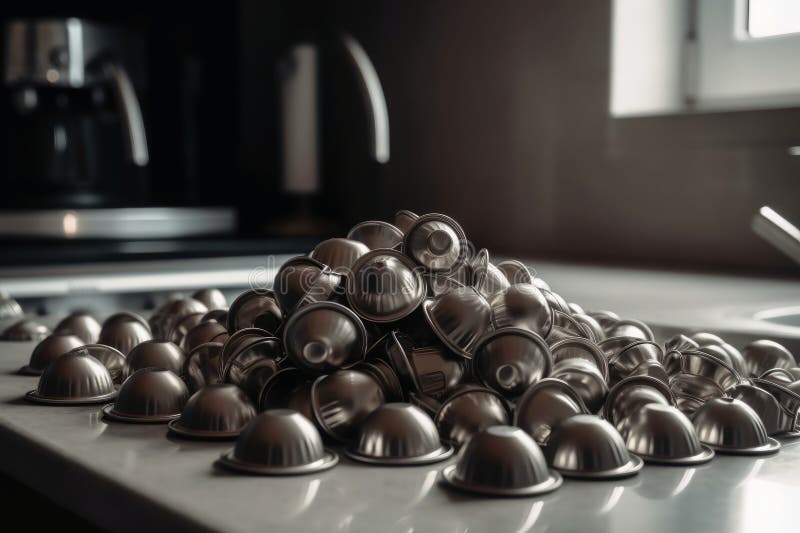 A Large Pile of Empty Aluminium Coffee Capsules Next To a Coffee ...