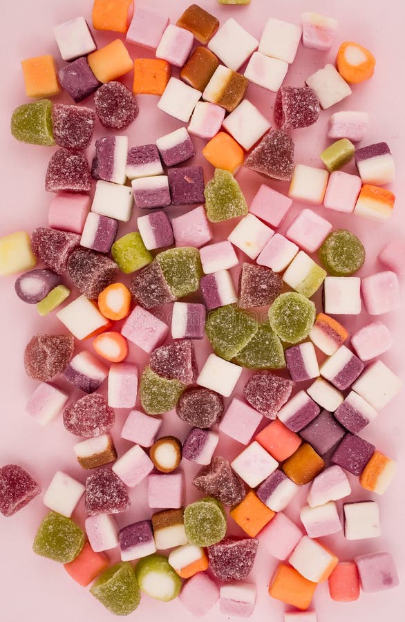 A Large Pile of Mixed Sweets on Wooden Background Stock Photo - Image ...