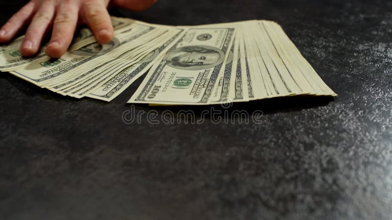 A Large Pile of Money is Lying on the Table, Which is Being Stretched ...