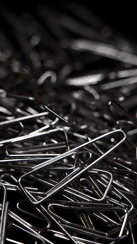A Large Pile of Triangular Shaped Shiny Silver Paper Clips Stock Image ...