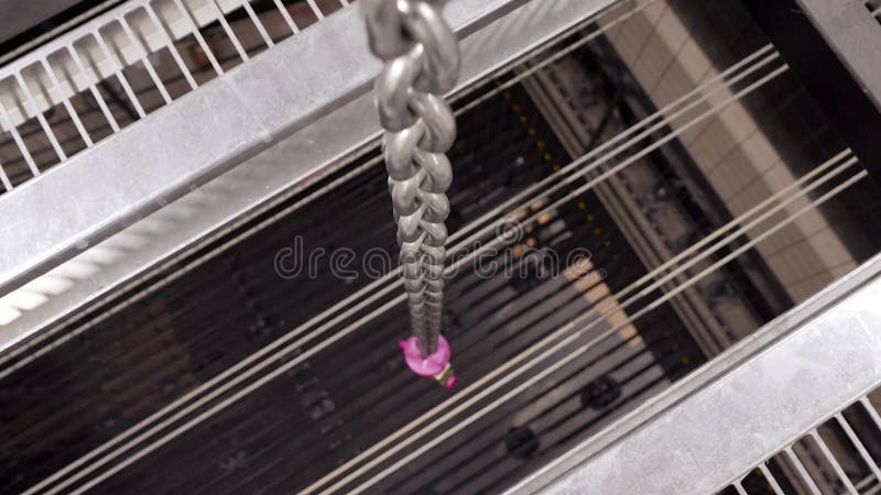 Large Pink Hook on a Chain is Lowered through the Raised Floor Stage ...