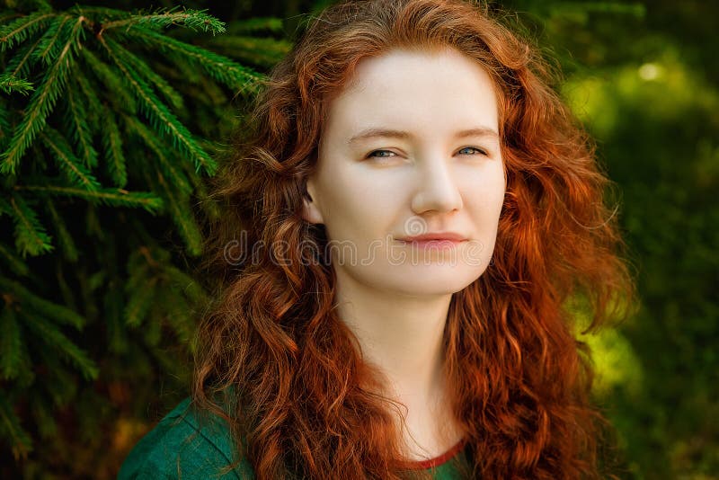 A Large Portrait Of A Beautiful Red Haired Woman Against The Background