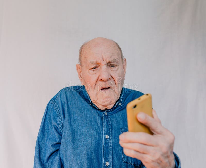 A Large Portrait of an Old Man in a Blue Shirt Looking at the Phone ...