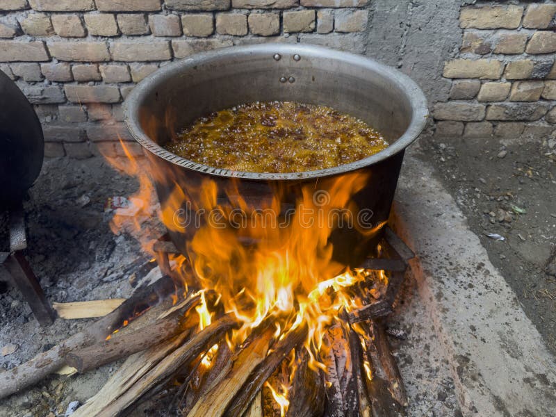 Large Pot of Boiling Oil Over Open Fire for Outdoor Cooking in a ...