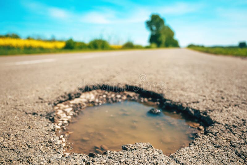 Large Pothole Filled with Water on a Road between Forests Stock Image ...