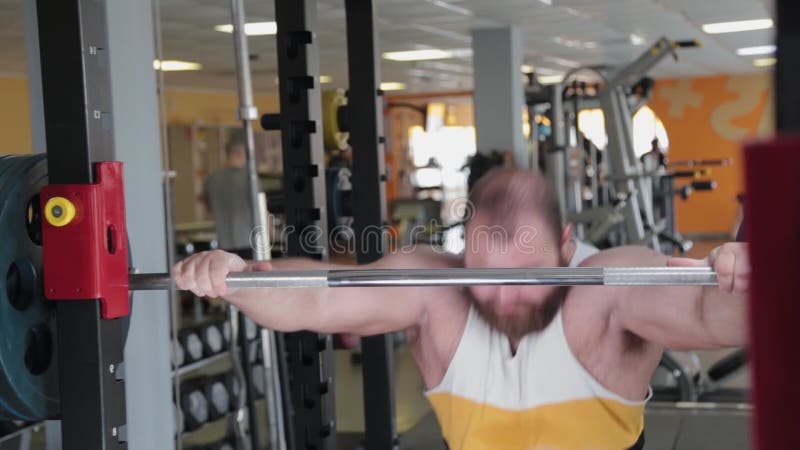 A Large and Powerful Weightlifter Bites the Barbell Angrily before ...