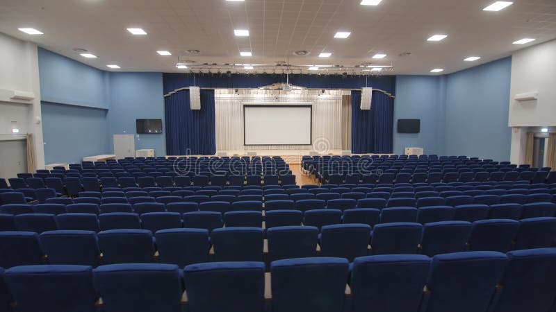 Projection Screen on Stage and Chairs in Conference Hall Stock Video ...