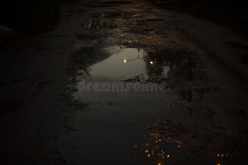 Large Puddle in Dark. Reflection of Light in Puddle Stock Photo - Image ...