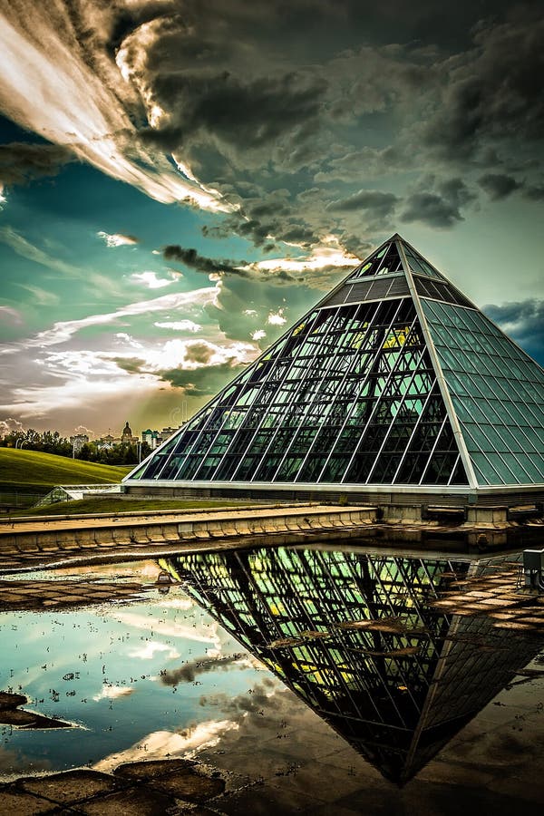 A Large Pyramid Building with a Large Glass Dome on Top Stock Photo ...