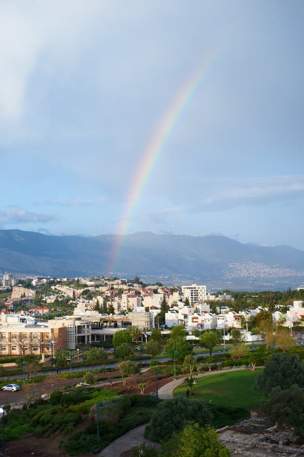 Large rainbow over city stock image. Image of leaves - 53581261
