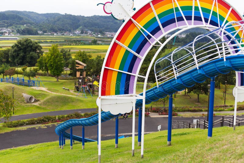A Large Rainbow Slide in a Park Editorial Stock Image - Image of play ...